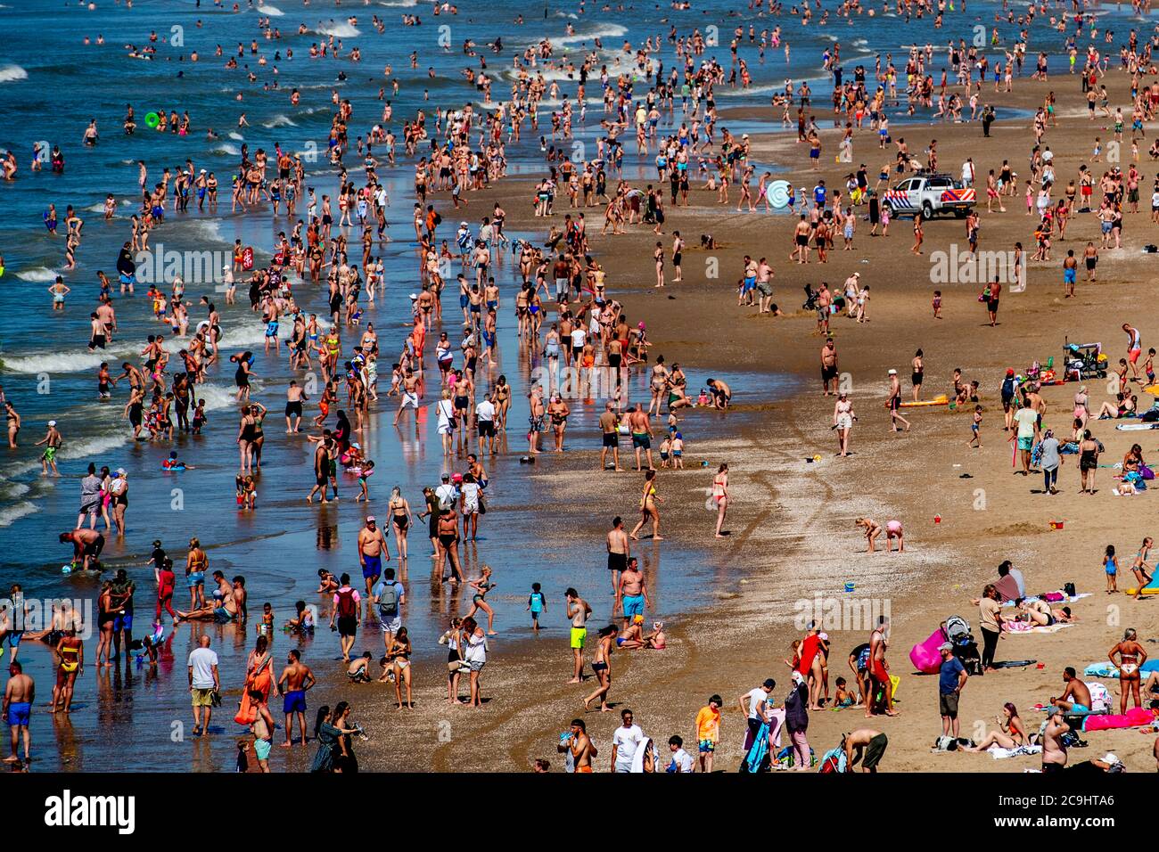 Crowds of people enjoy the sun and the warm weather during the heat ...