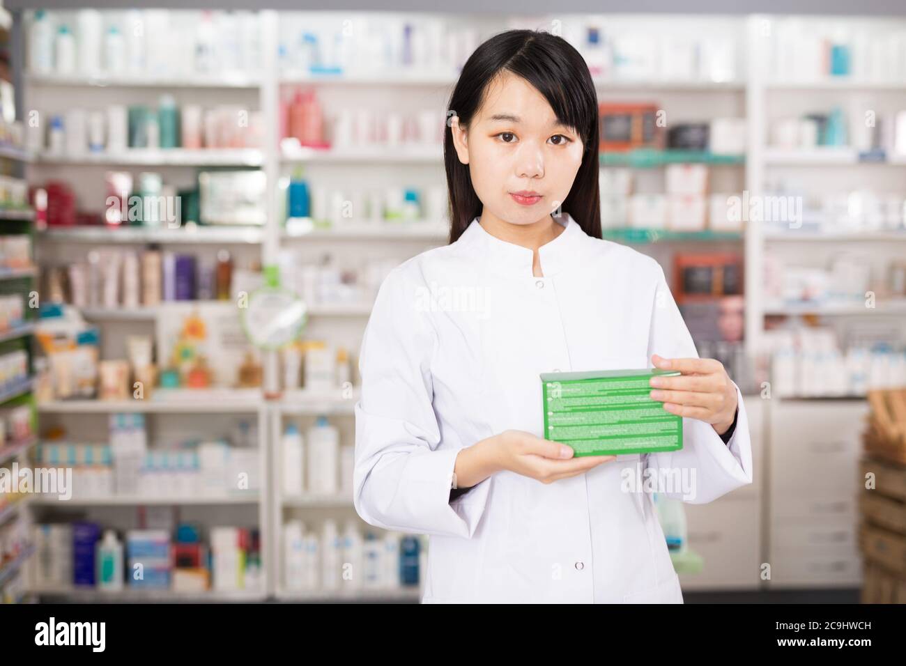 Chinese female pharmacist demonstrating assortment of pharmacy Stock ...