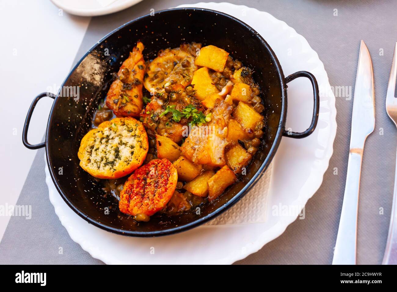 Fish in lemon sauce - dish of Valencian cuisine Stock Photo - Alamy