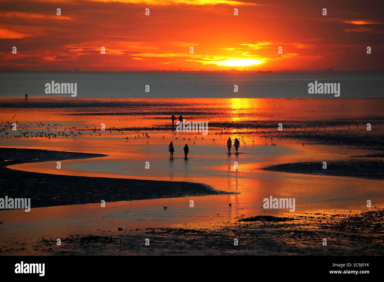 Heacham, UK. 30th July, 2020. After a very hot day, people wait for the ...