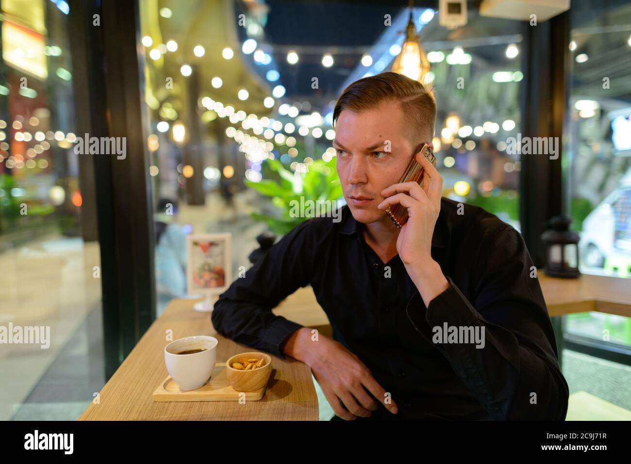Young handsome businessman relaxing at the coffee shop Stock Photo - Alamy