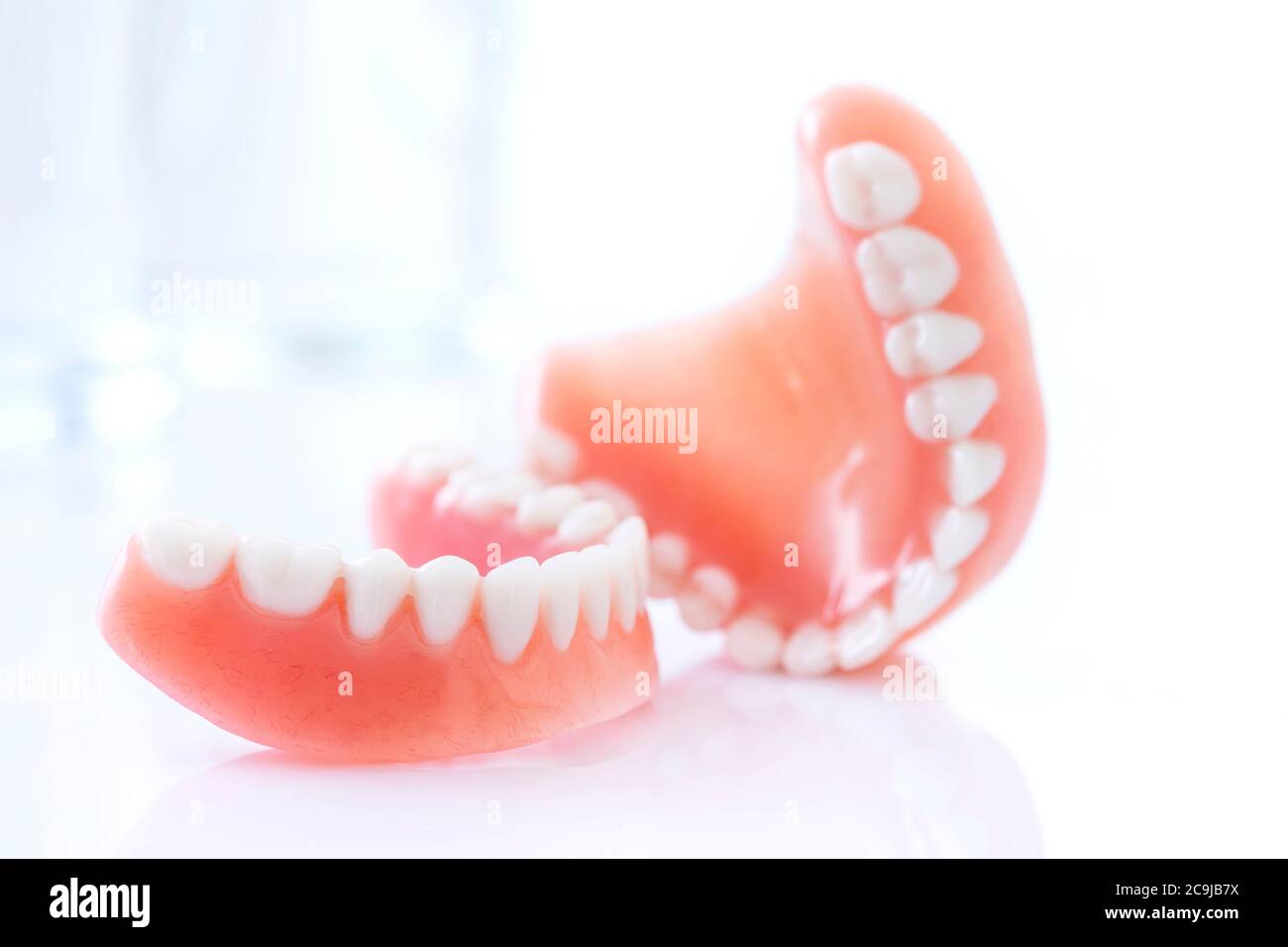 Dentures against a white background Stock Photo - Alamy