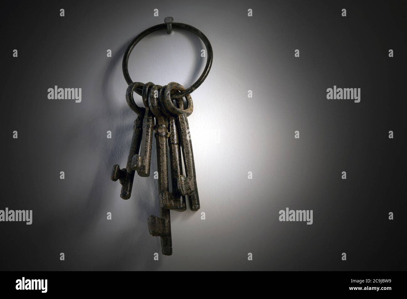 Old keys against a plain grey background Stock Photo - Alamy