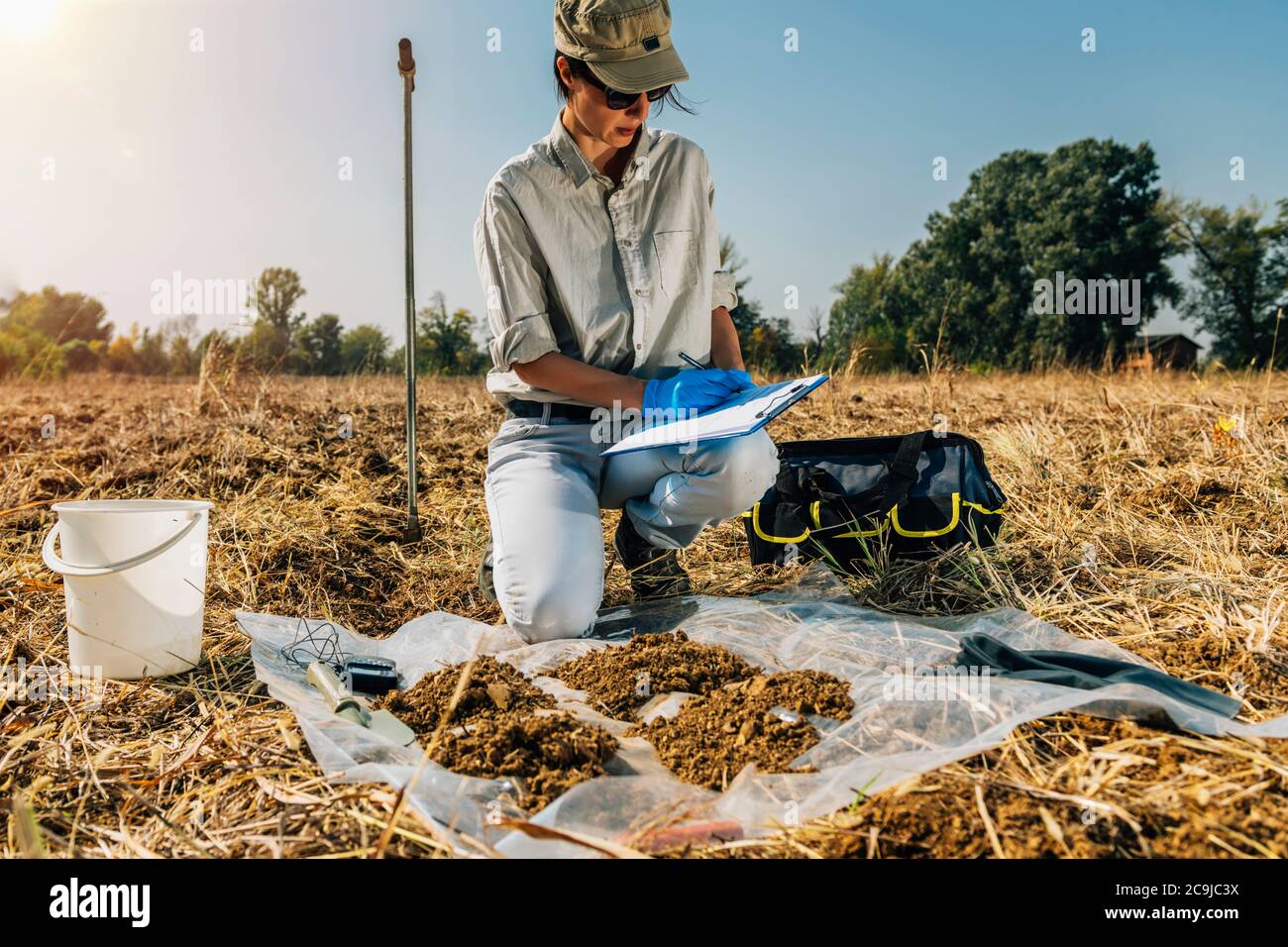 Soil Test. Female agronomist taking notes in the field Stock Photo - Alamy