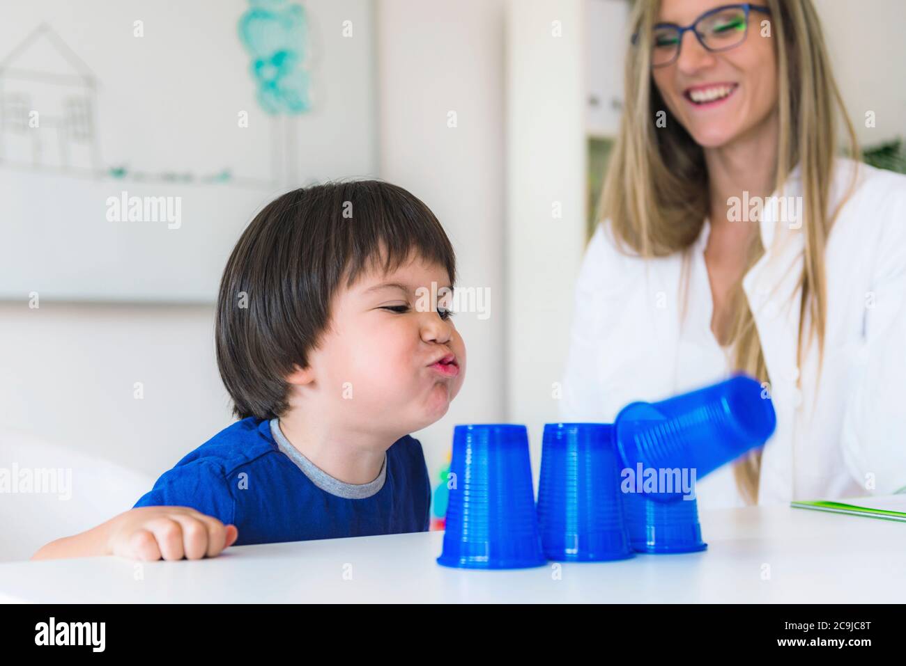 Child psychology, toddler doing tests with plastic cups Stock Photo - Alamy