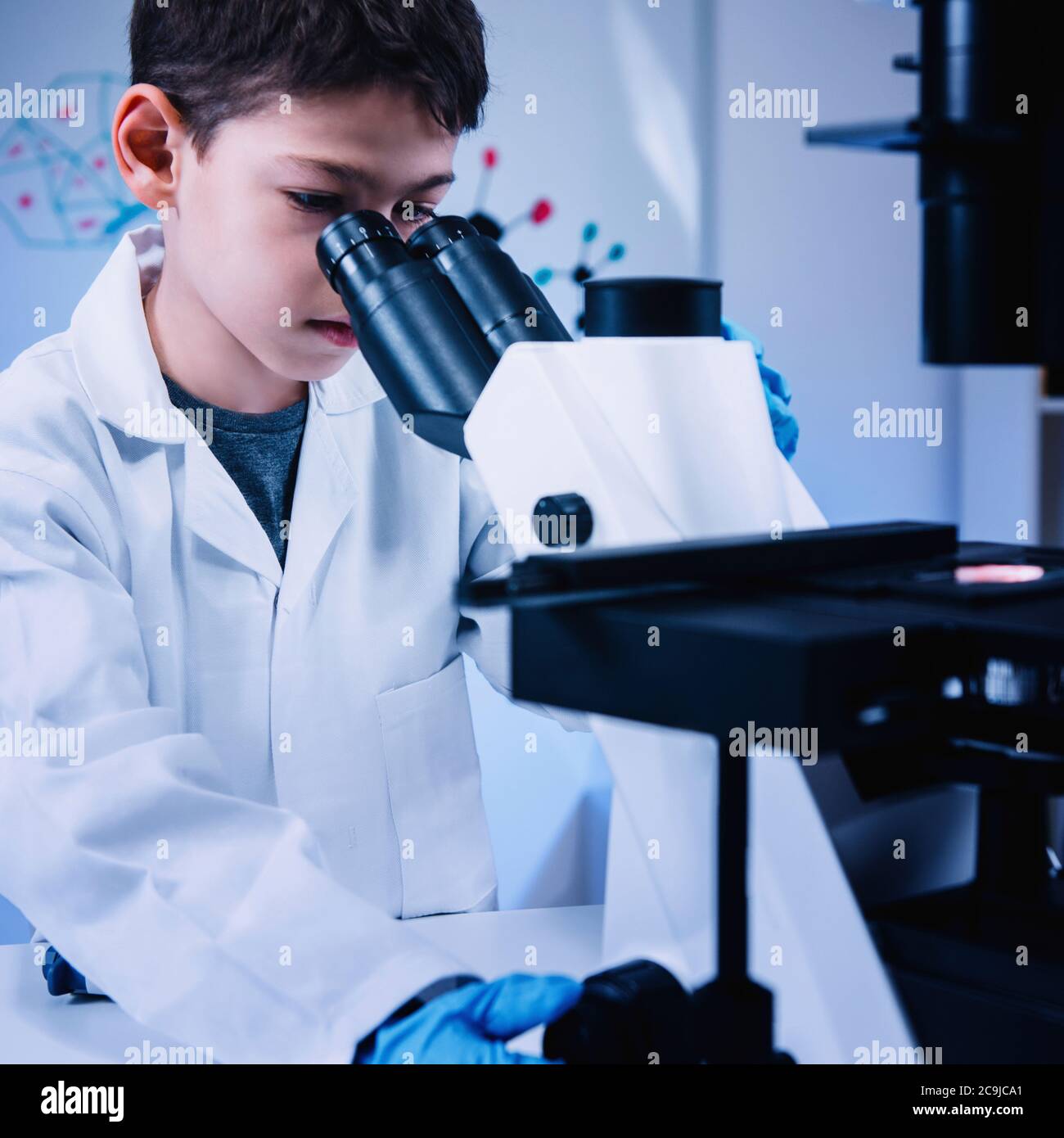 Schoolboy using light microscope Stock Photo - Alamy