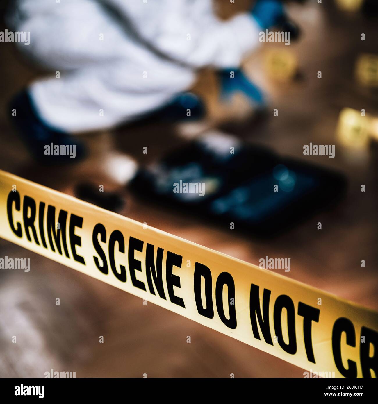 Crime scene. Forensics expert collecting evidence from a crime scene ...