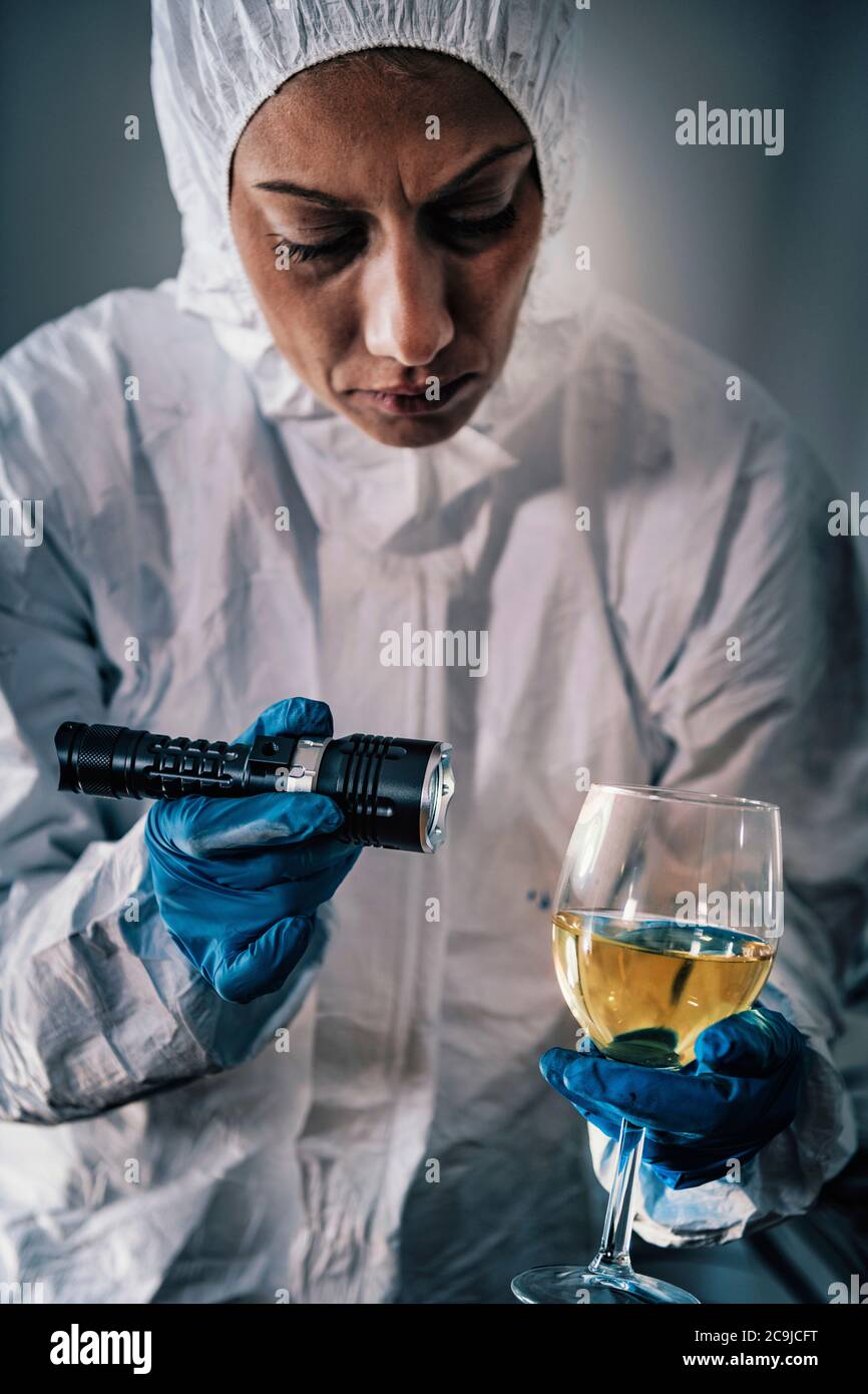Crime scene. Forensics expert examining evidence at a crime scene Stock ...