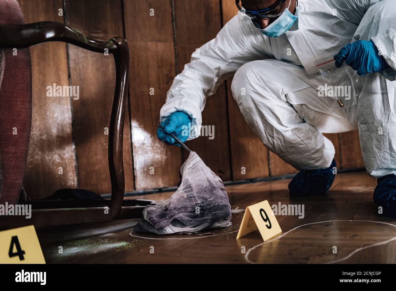 Crime scene. Forensics expert collecting evidence from a crime scene Stock Photo - Alamy