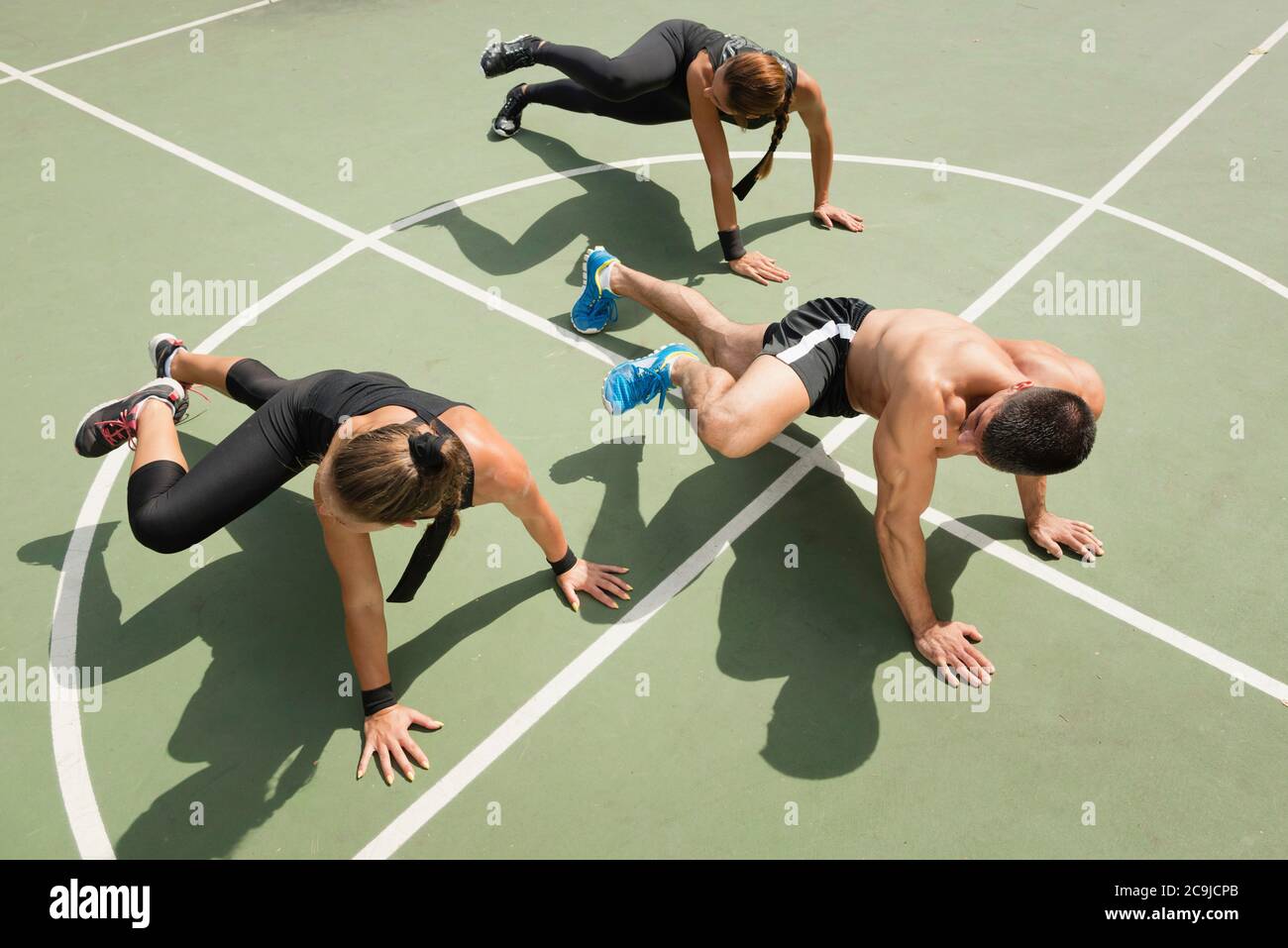 Plank obliques exercise, fitness team promoting insanity workout Stock ...