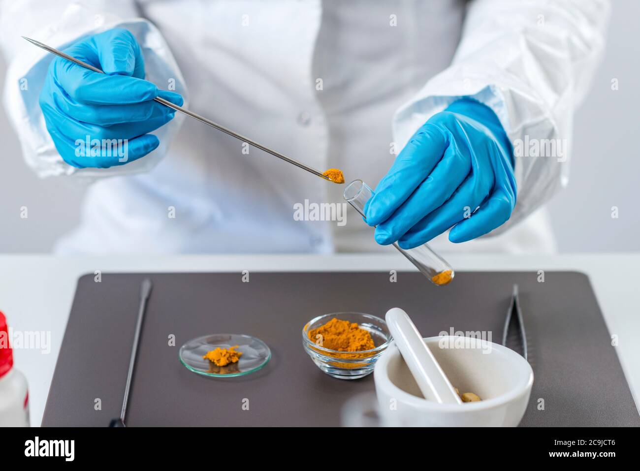 Quality control expert inspecting turmeric in the laboratory Stock ...