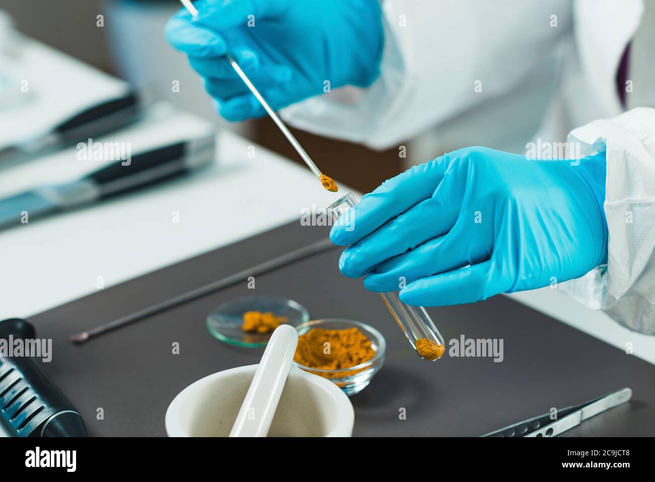 Quality control expert inspecting turmeric in the laboratory Stock ...