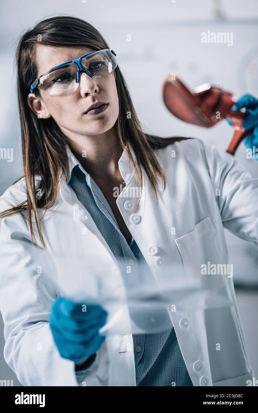 Forensic Science in Lab. Forensic Scientist examining shoe for evidence ...