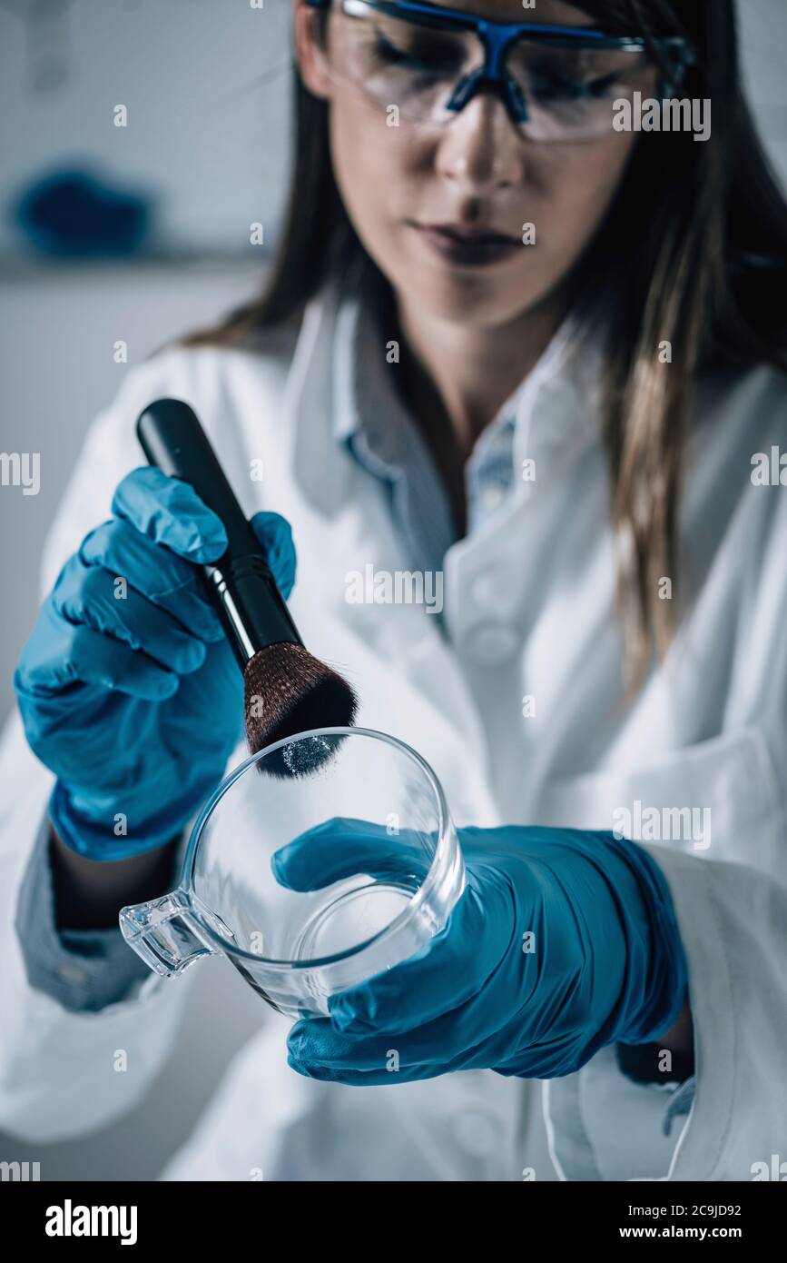 Forensic Science in Lab. Forensic Scientist examining glass for ...