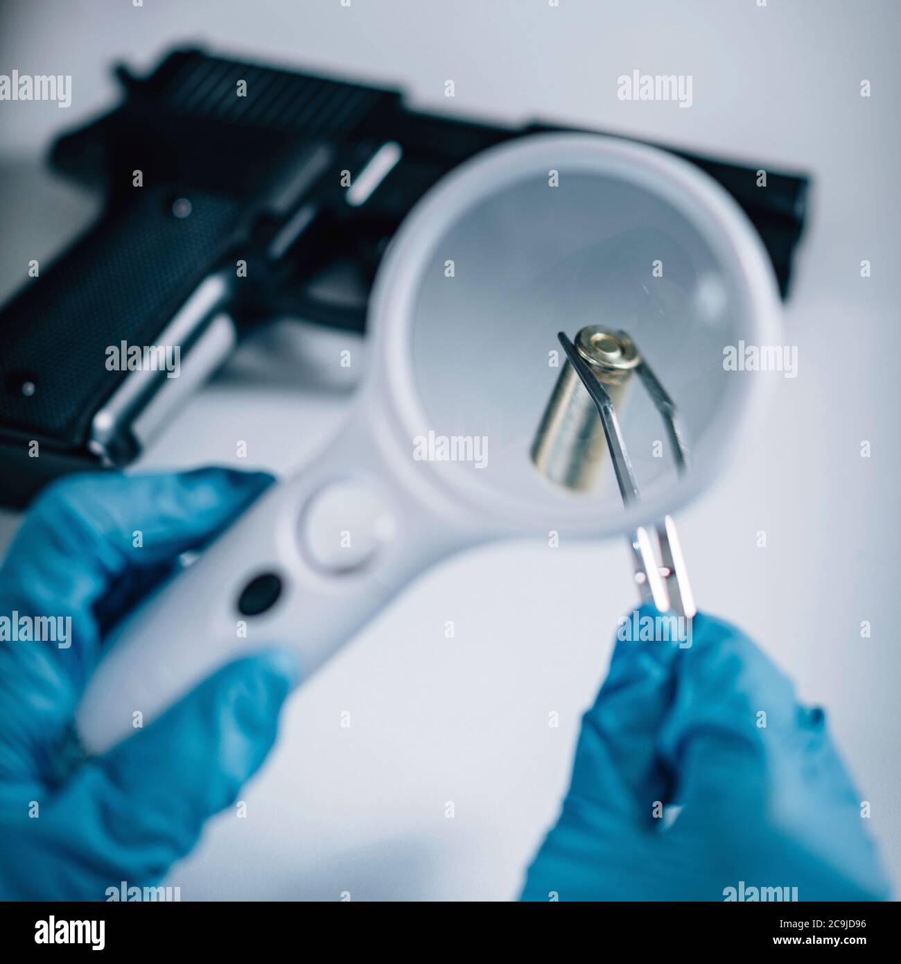 Forensic Science in Lab. Forensic Scientist examining bullet shell for ...