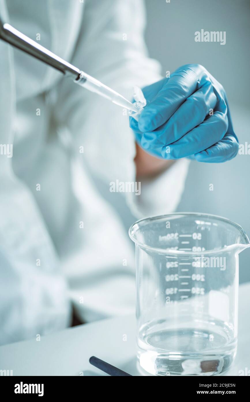 Microbiology. Hands of a microbiologist pipetting sample Stock Photo ...