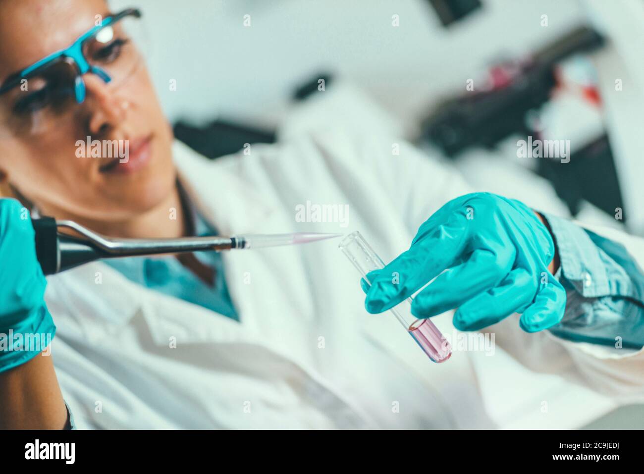 Life science research. Technician using micro pipette Stock Photo - Alamy