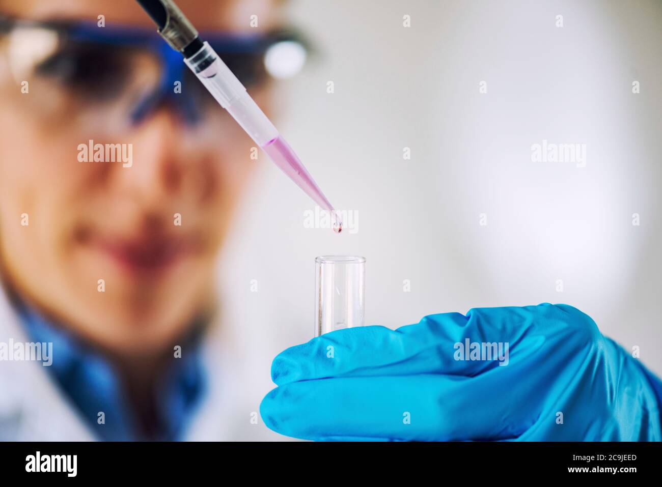 Laboratory technician with micro pipette Stock Photo - Alamy