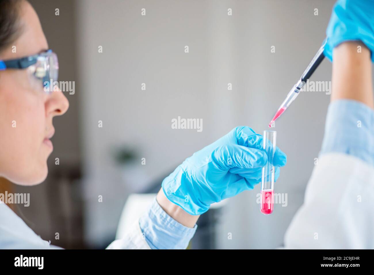 Laboratory technician with micro pipette Stock Photo - Alamy