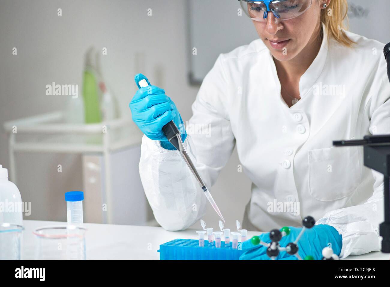 Scientist pipetting sample Stock Photo - Alamy