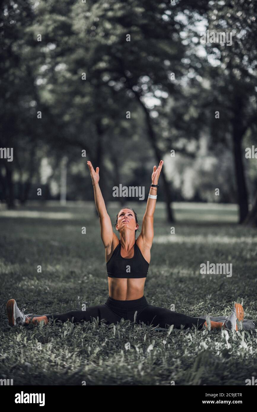 Stretching. Female athlete stretching after exercise Stock Photo - Alamy