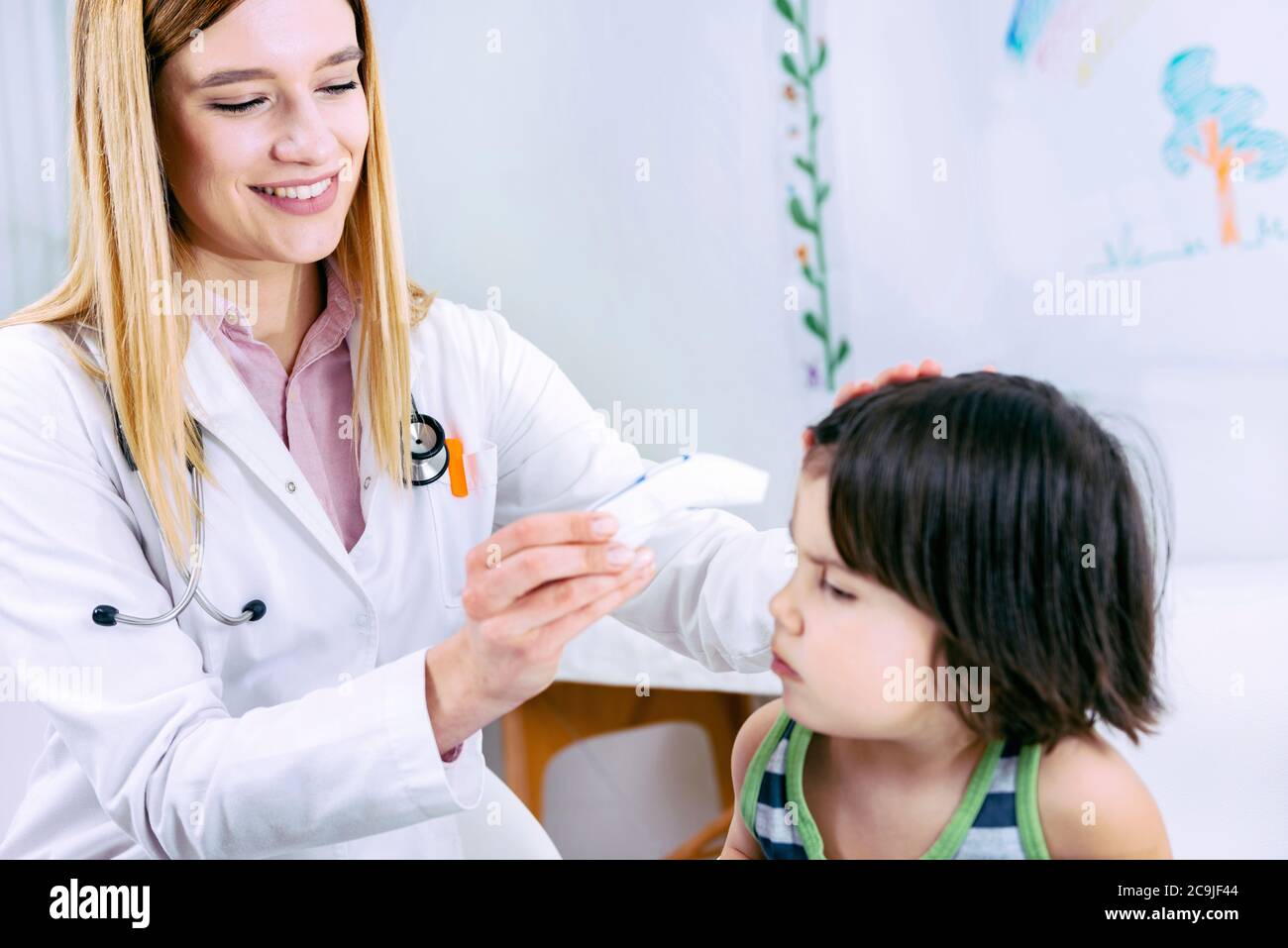 Paediatrician measuring boy's temperature Stock Photo - Alamy