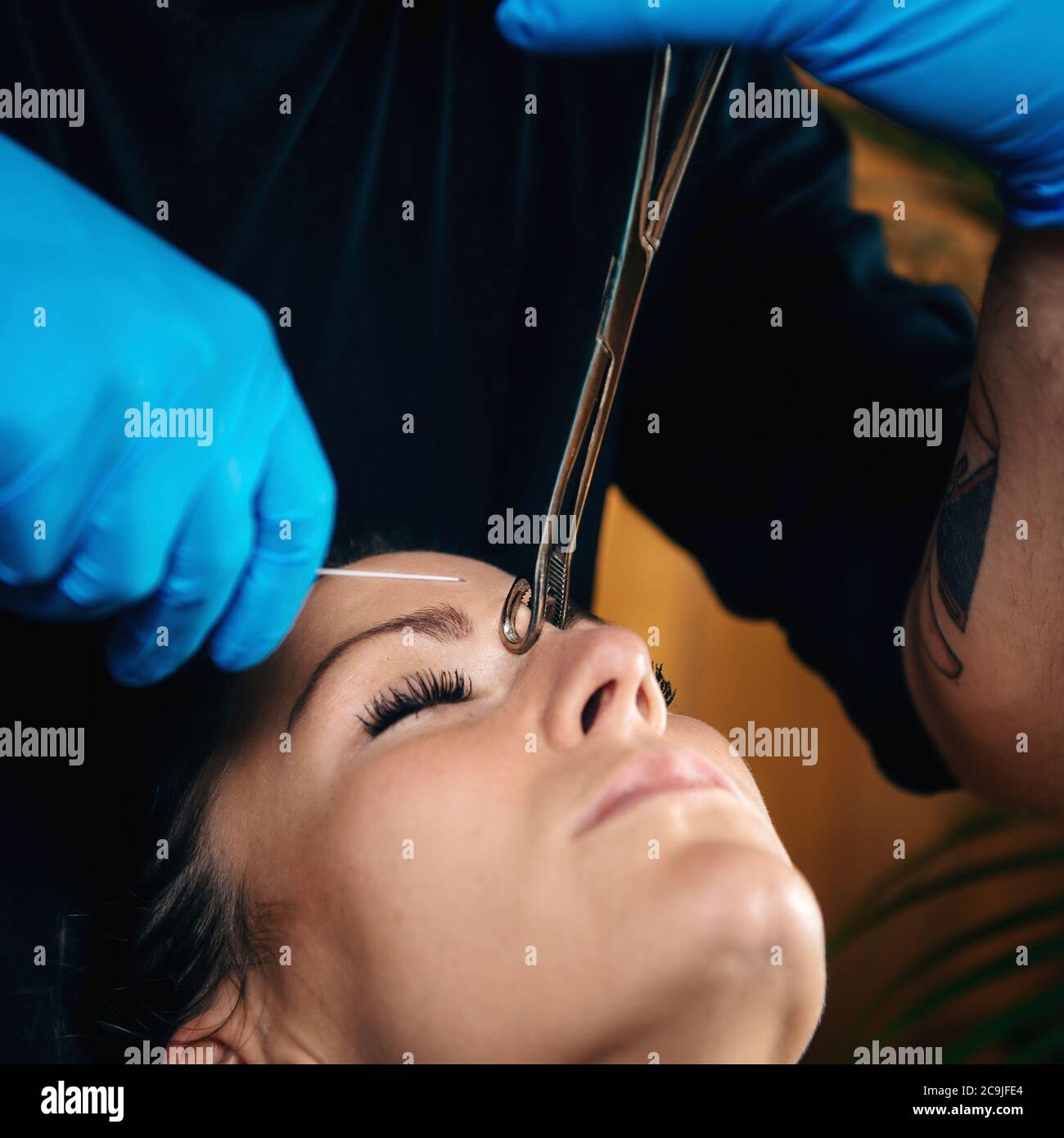 Nose bridge piercing Stock Photo - Alamy