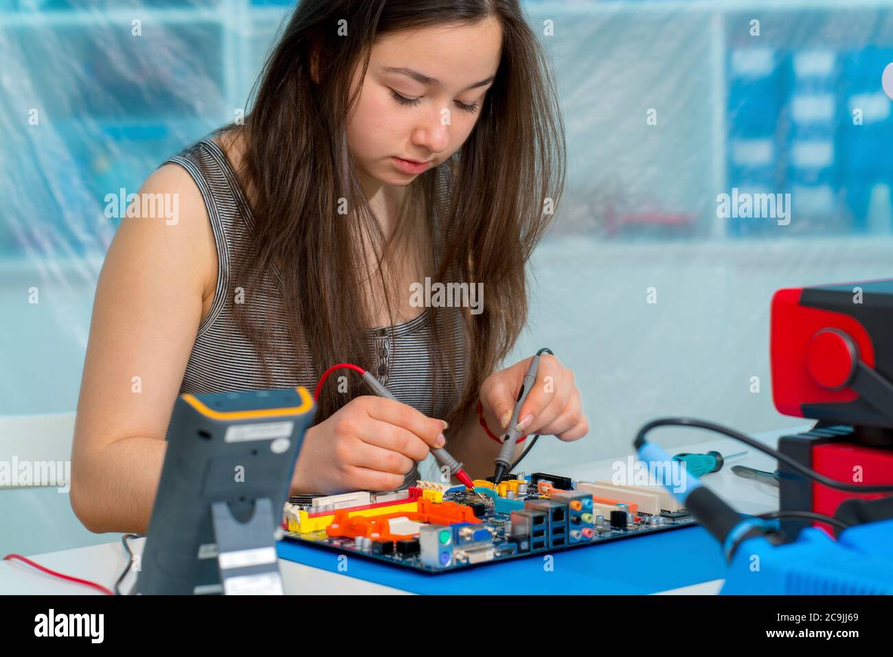 Girl working on electronics project Stock Photo - Alamy