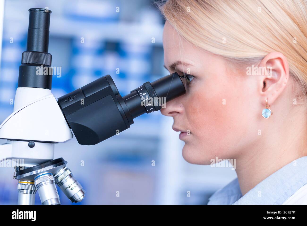 Researcher using microscope Stock Photo - Alamy