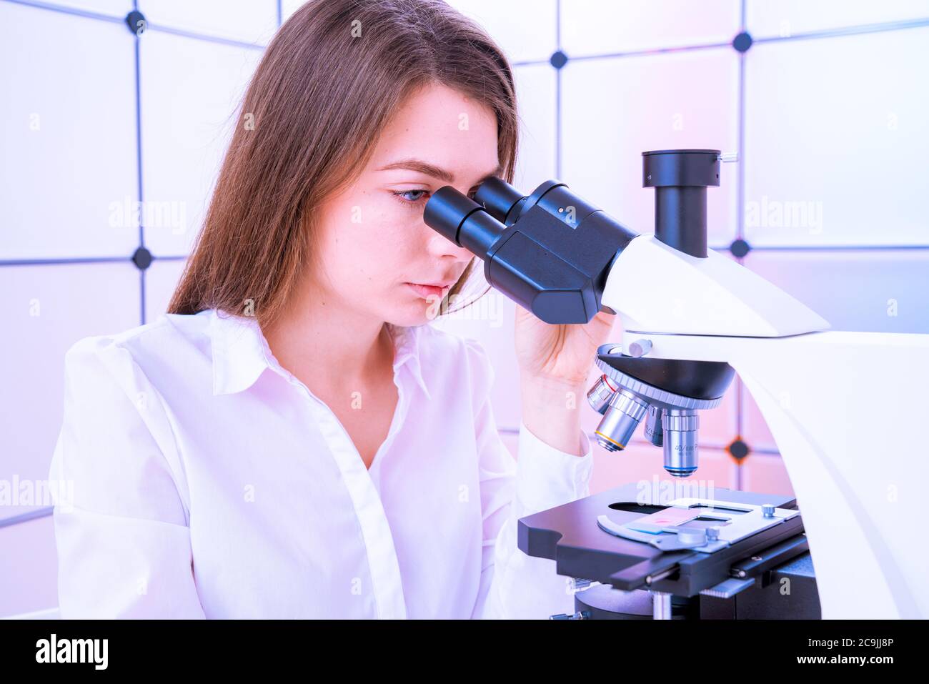 Researcher using microscope Stock Photo - Alamy