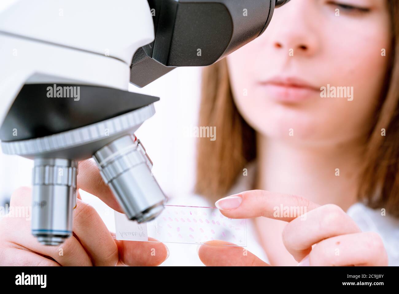 Researcher using microscope Stock Photo - Alamy