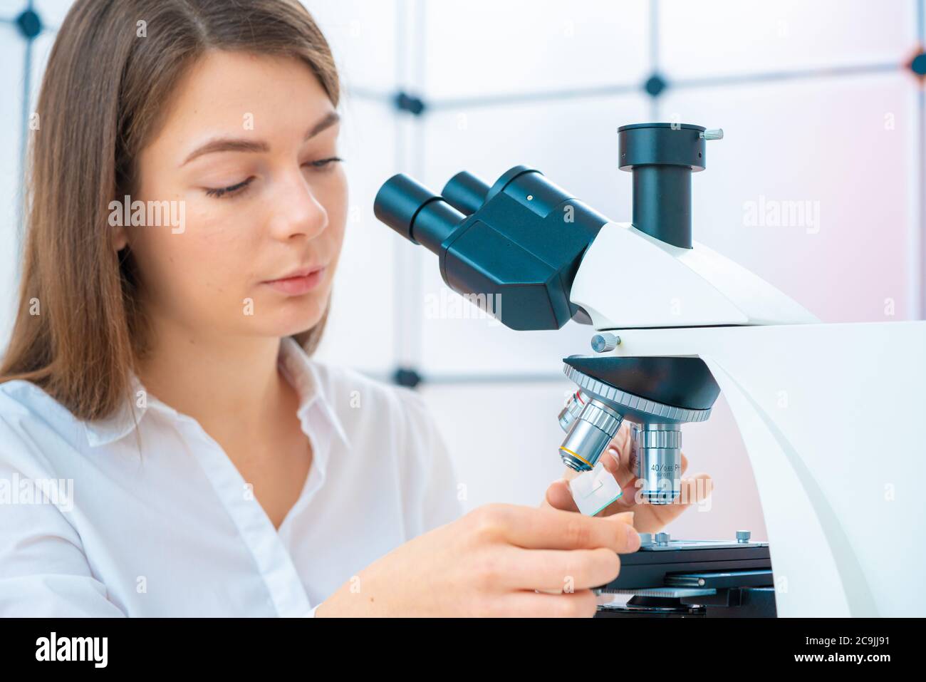 Researcher using microscope Stock Photo - Alamy