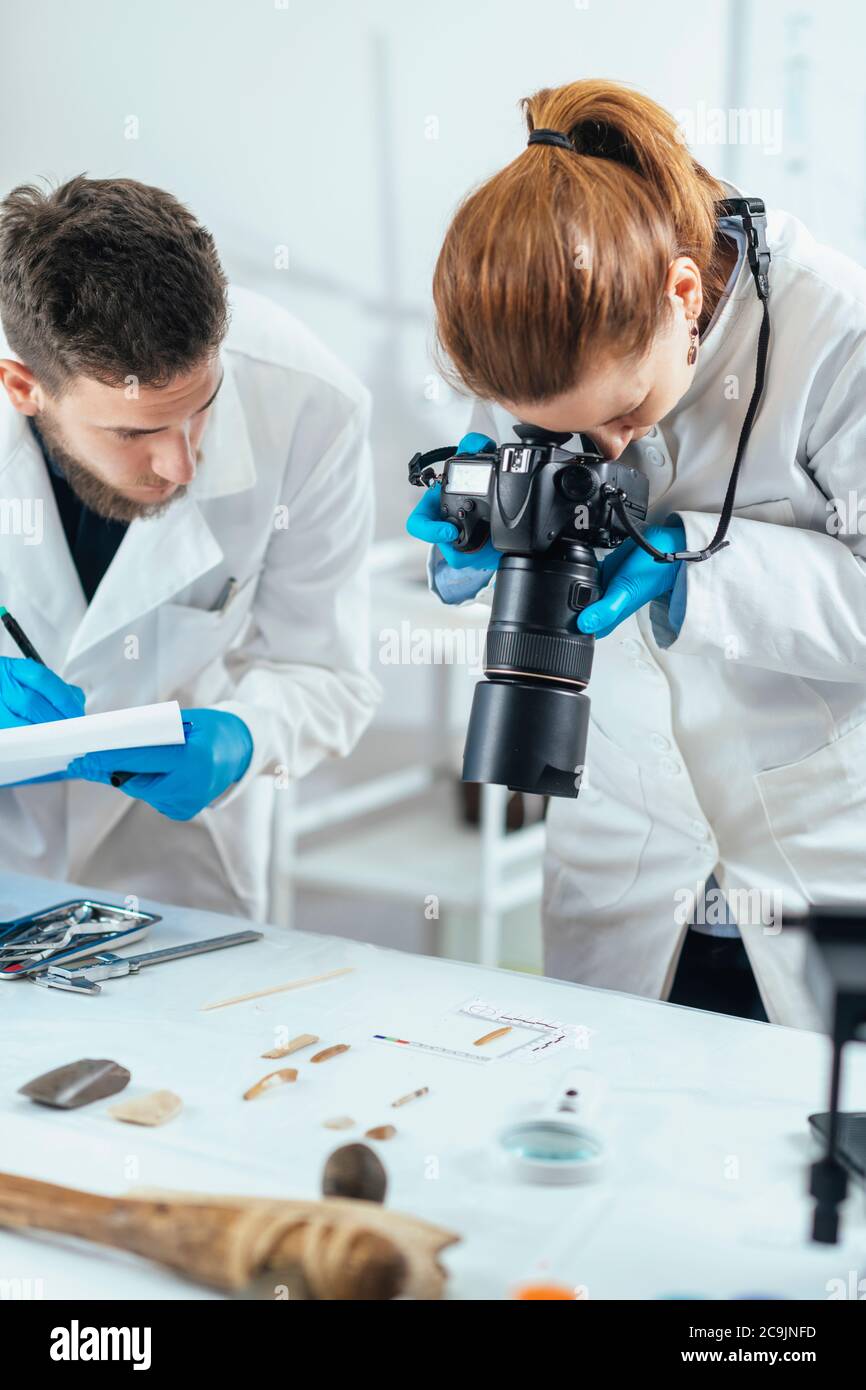 Young archaeology researchers document lithics with a camera in ...
