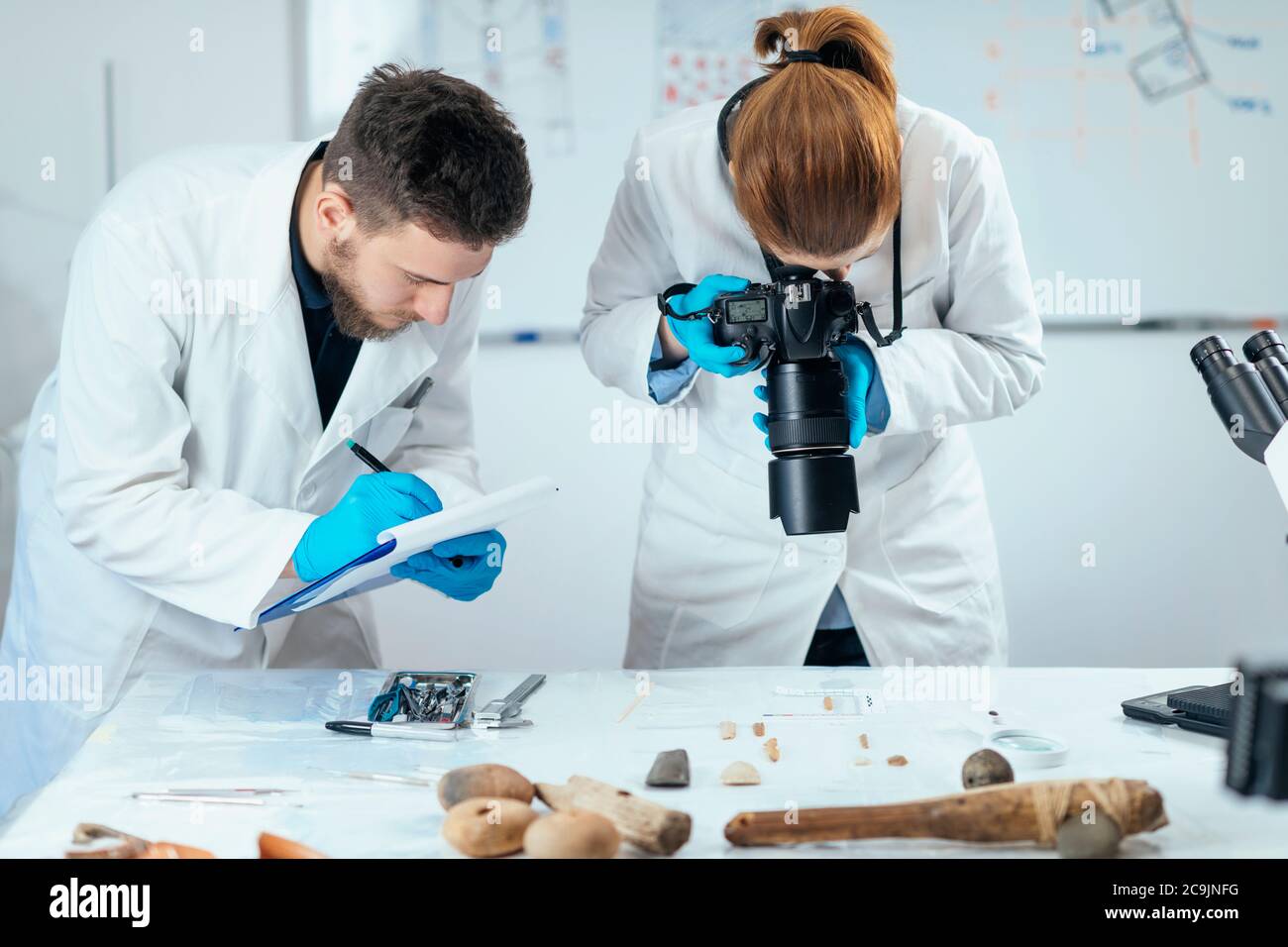 Young archaeology researchers document lithics with a camera in ...