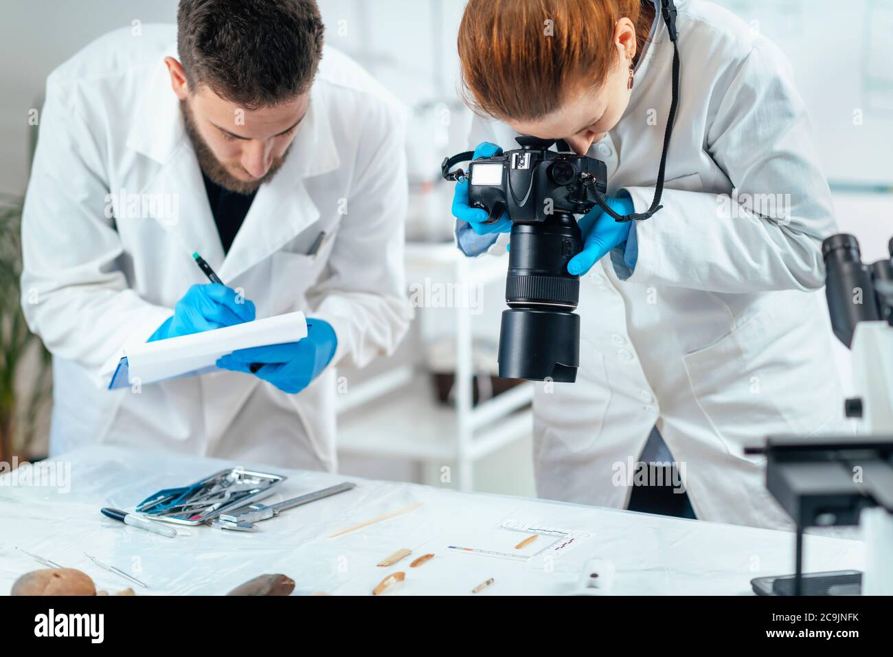 Young archaeology researchers document lithics with a camera in ...