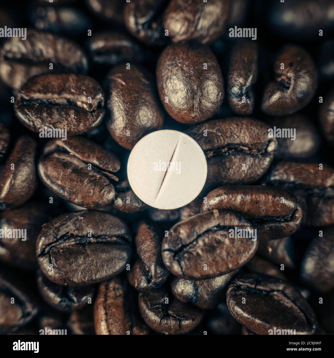 Caffeine supplement pill and roasted coffee beans Stock Photo - Alamy