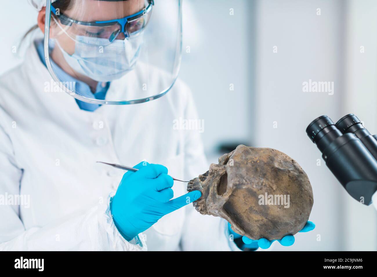 Ancient DNA analysis. Female scientist holding micro tube with sample ...