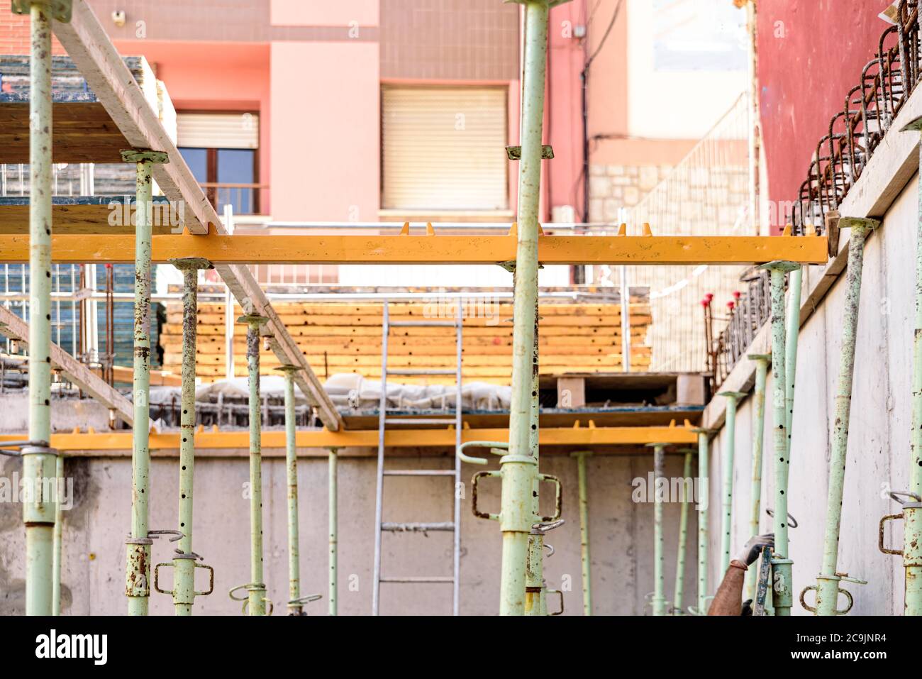 Workers placing support bars to cement the structure of a building with ...