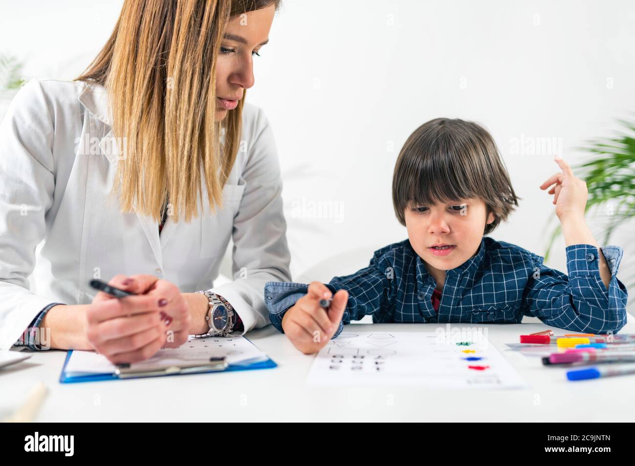 Psychology test for children. Toddler undergoing a logic test with ...