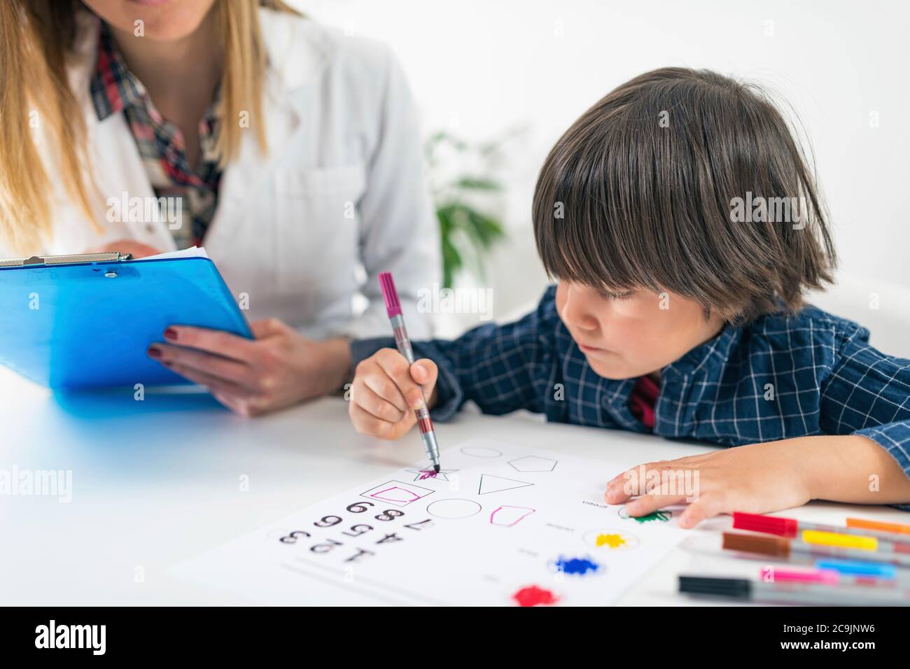 Psychology test for children. Toddler colouring shapes Stock Photo - Alamy
