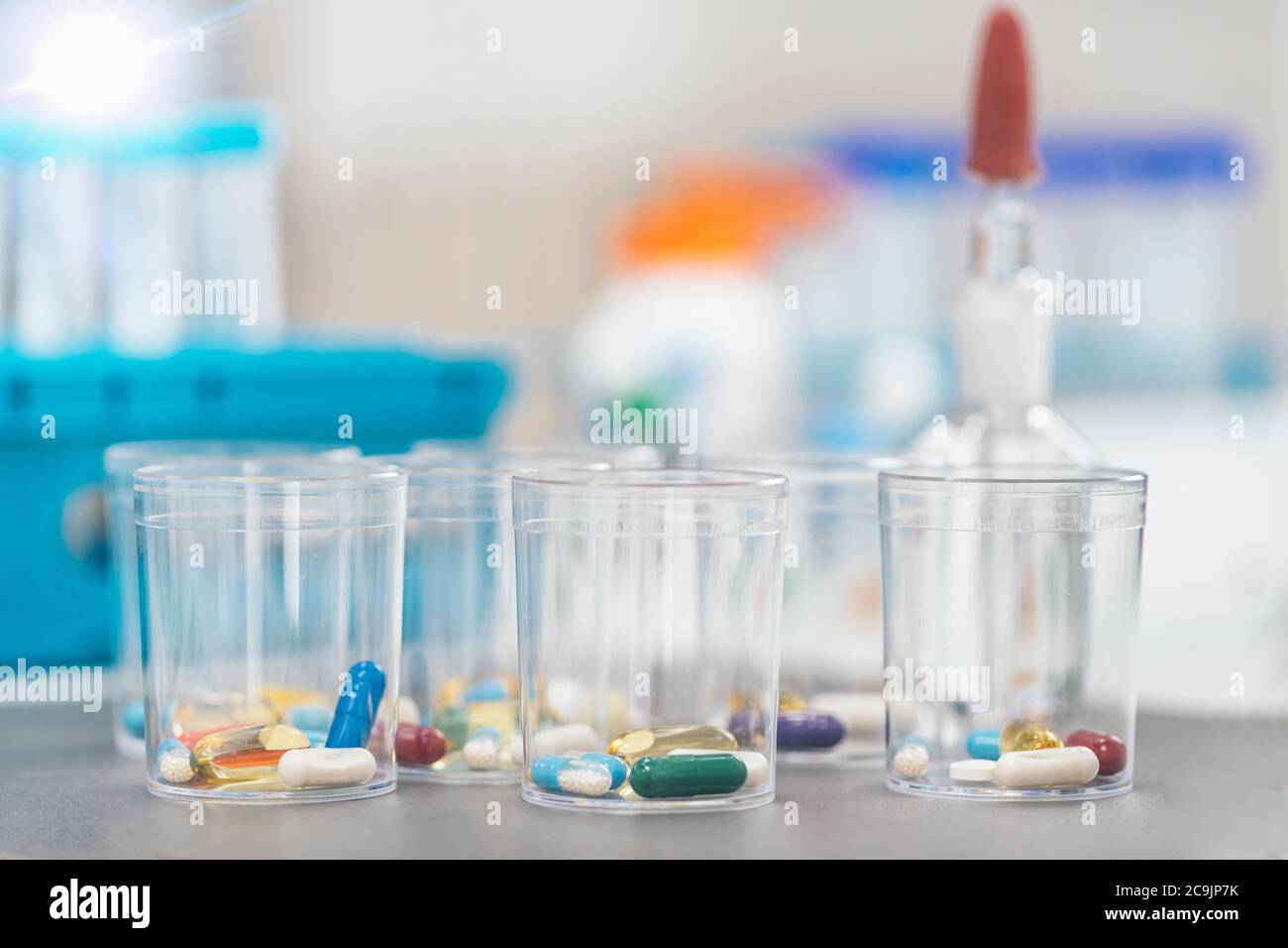 Pills in disposable plastic cup. Medication concept Stock Photo - Alamy