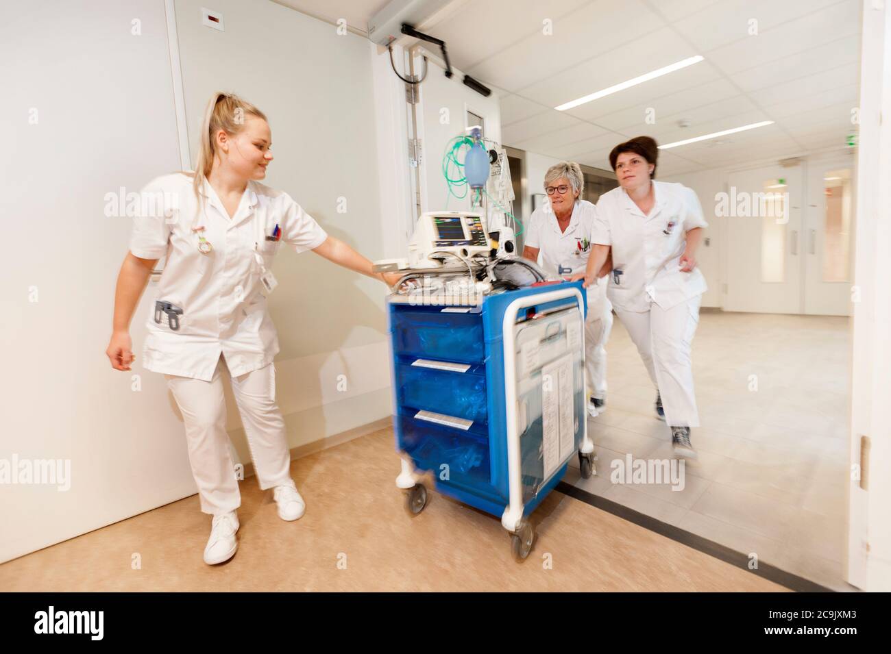 Geriatric hospital ward. Nurses running through the hall of a hospital ...
