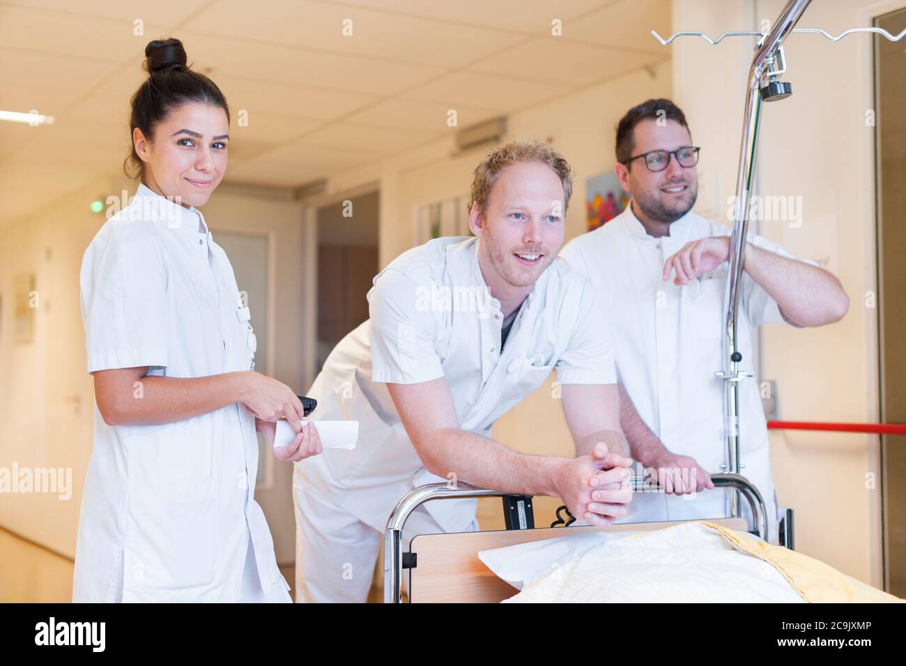 Three nurses in a hospital corridor Stock Photo - Alamy