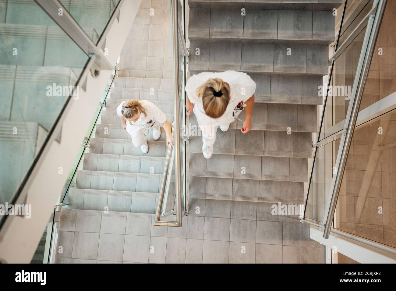 Nurses walking down the stairwell of a hospital Stock Photo - Alamy