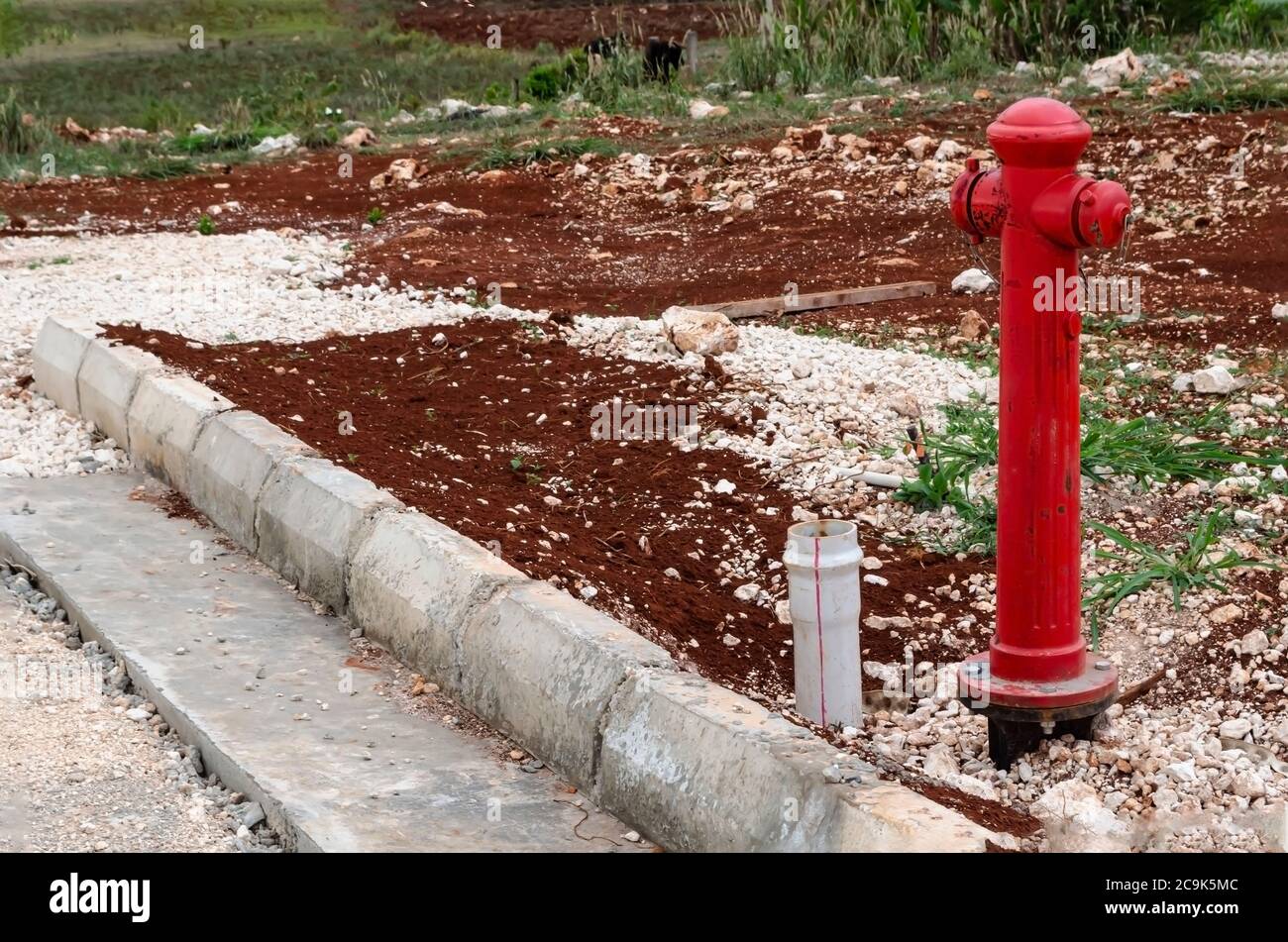 The red housing of a fire hydrant that is being installed at the inner ...