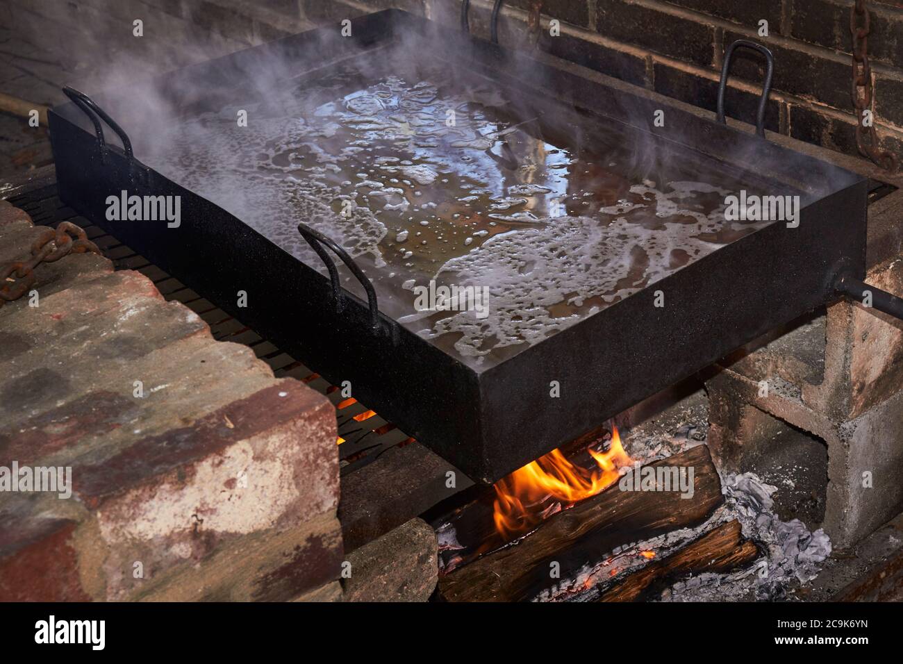Maple syrup being evaporated over an open fire in Lancaster ...