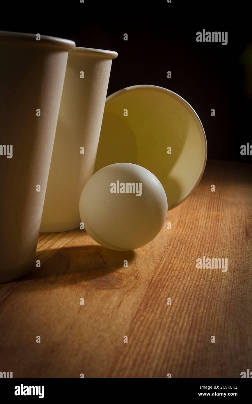 Disposable paper cups and ping pong ball Stock Photo - Alamy