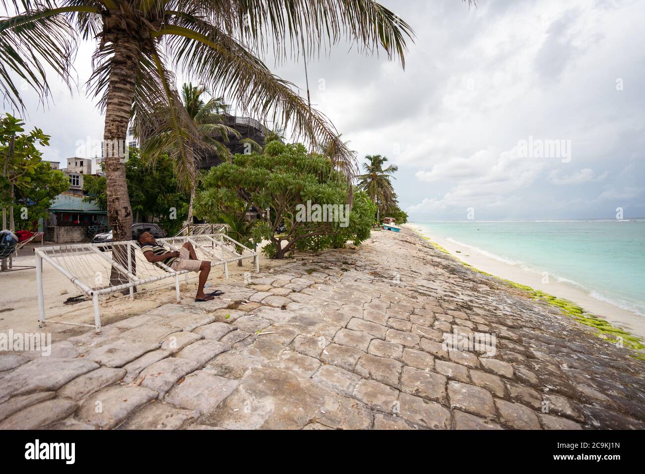 Hulumale / Maldives - August 20, 2019: man sitting on traditional rope ...