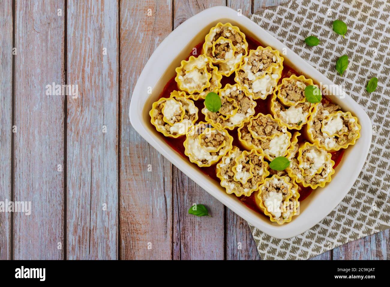 Stuffed pasta rolls with meat and ricotta cheese in baking bowl Stock ...
