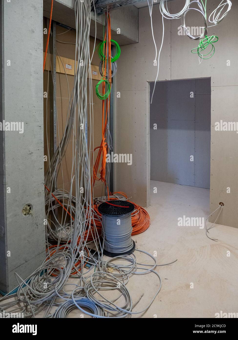 on a construction site many network and power cables hang from the ...